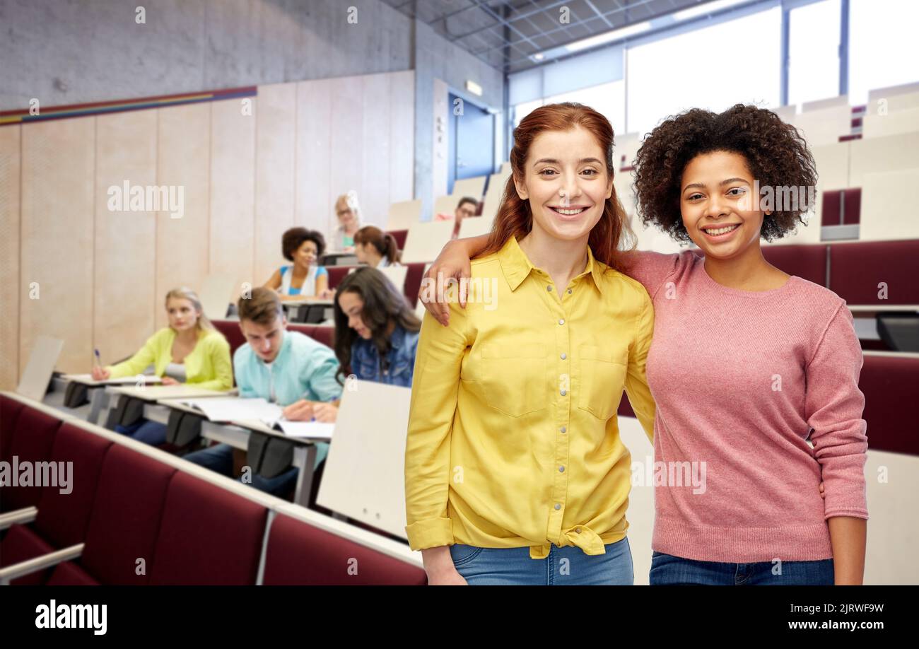 happy smiling student women hugging at university Stock Photo - Alamy
