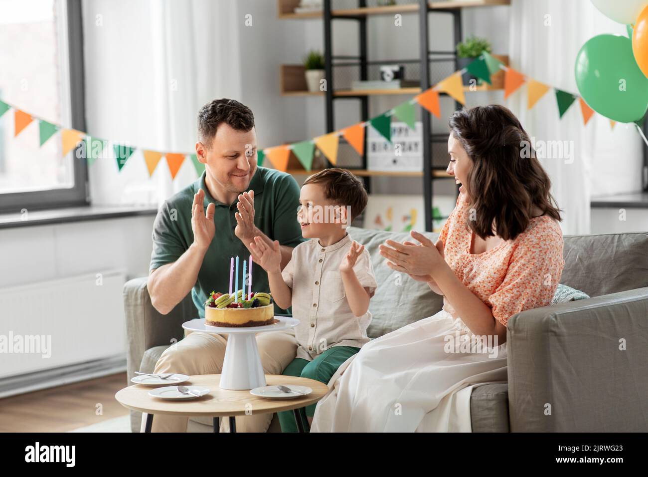 happy family with birthday cake at home Stock Photo - Alamy