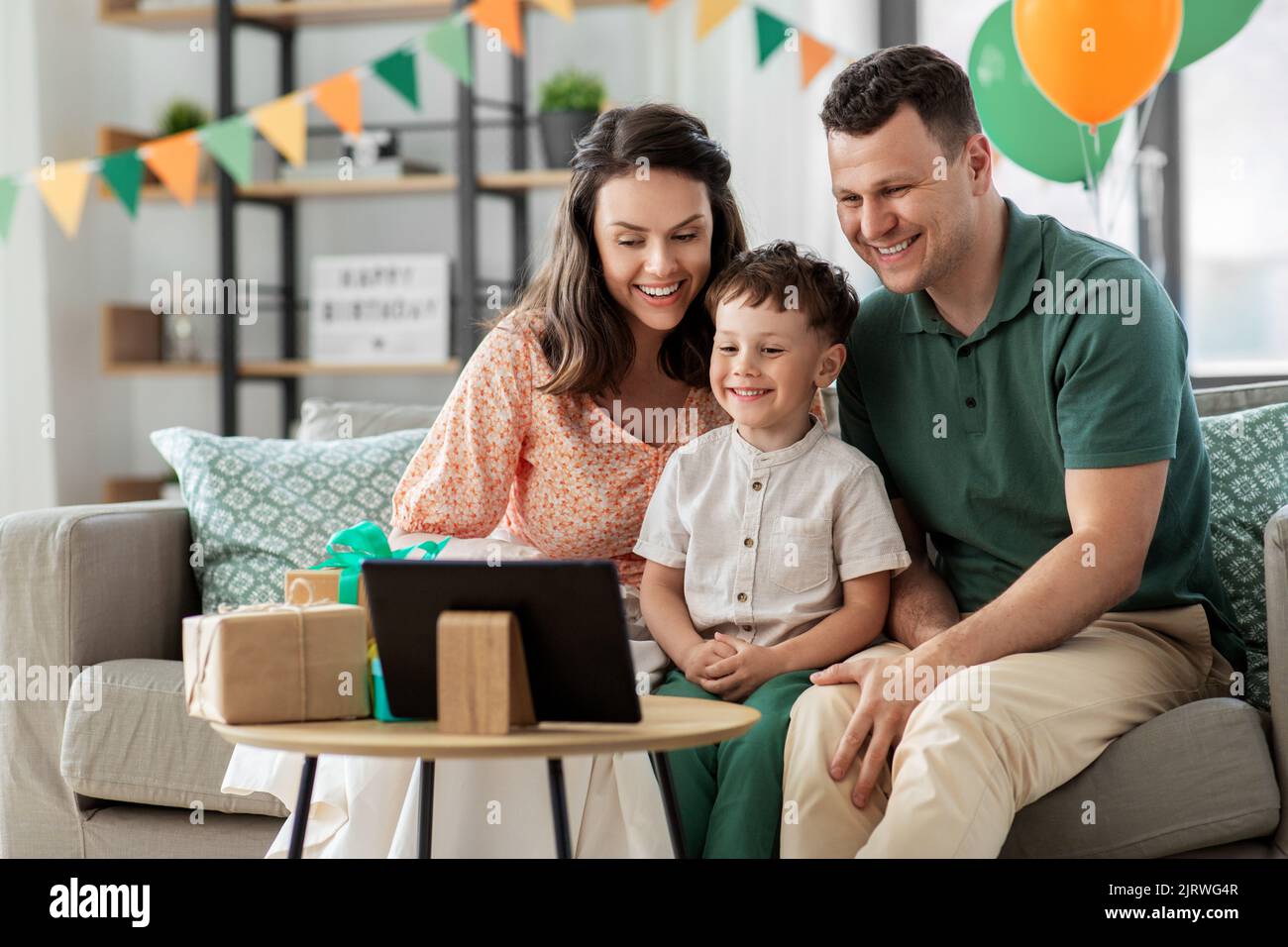 happy family with tablet pc at home on birthday Stock Photo - Alamy