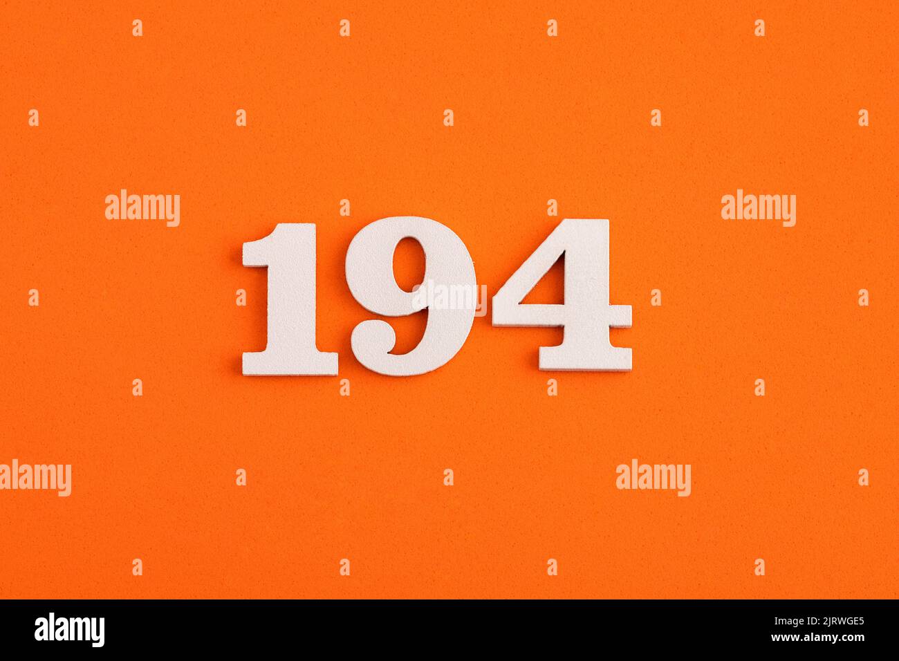 White wooden number 194 on eva rubber orange background Stock Photo - Alamy
