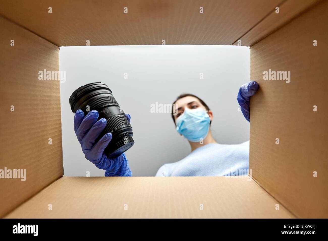 Female worker in mask packing hi-res stock photography and images - Alamy