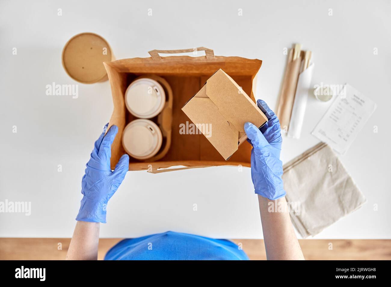 delivery woman in gloves packing food and drinks Stock Photo - Alamy