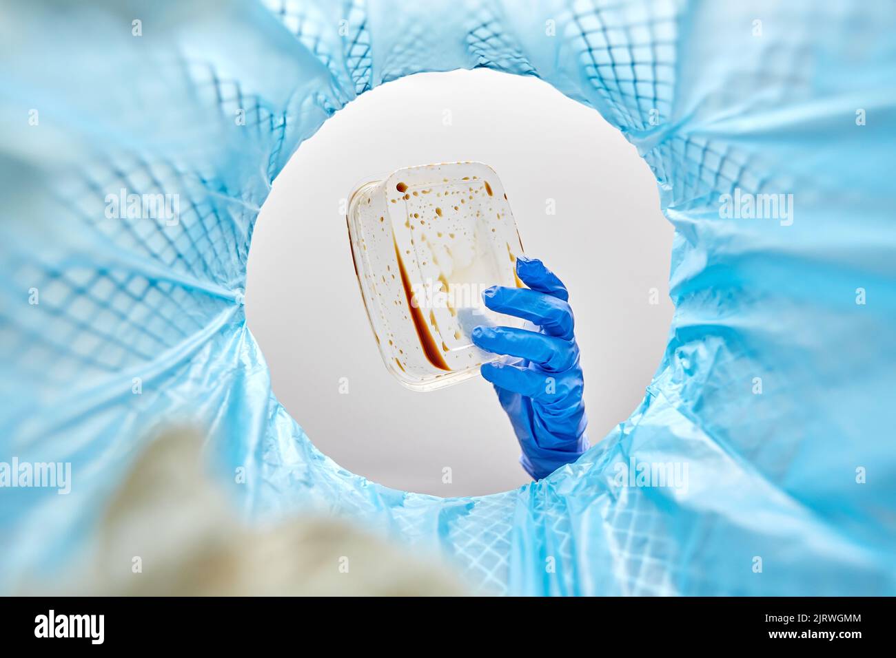hand throwing plastic container into trash can Stock Photo - Alamy