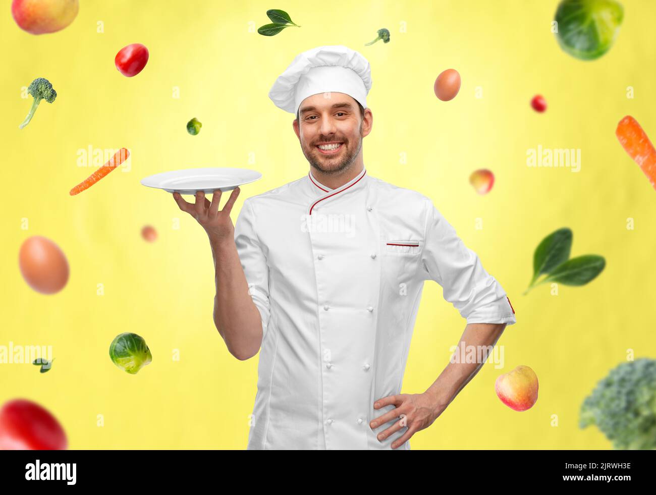 happy smiling male chef holding empty plate Stock Photo - Alamy