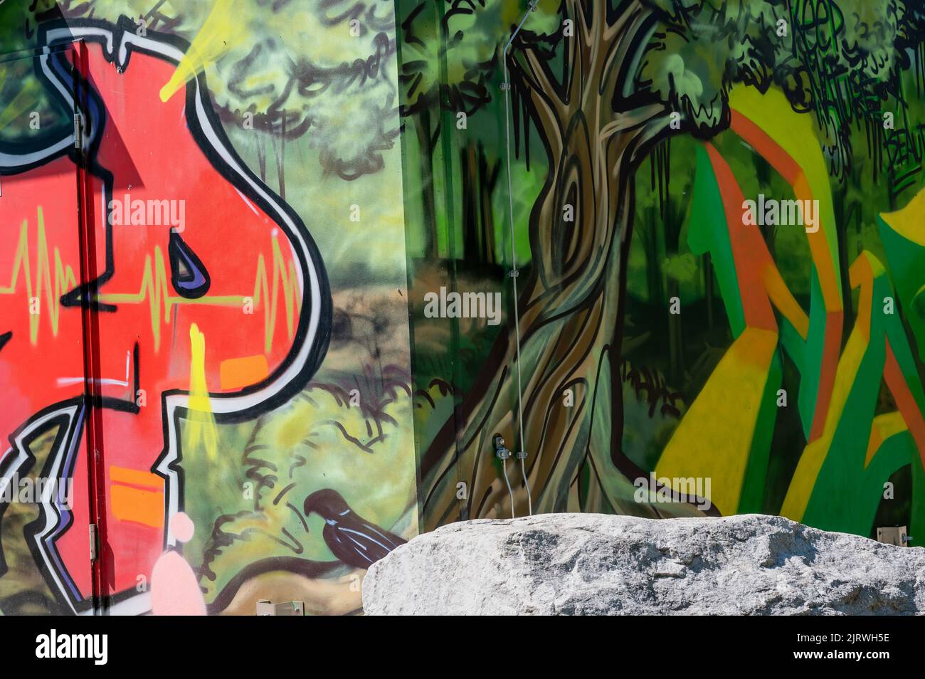 graffiti with the representation of a forest on a metallic wall of a ...