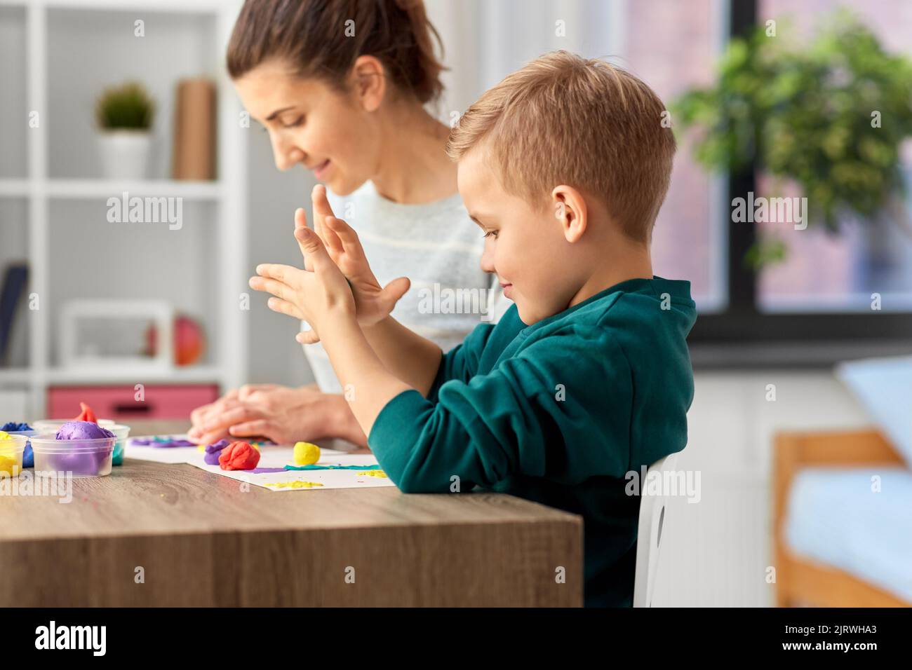 mother and son playing with modeling clay at home Stock Photo - Alamy