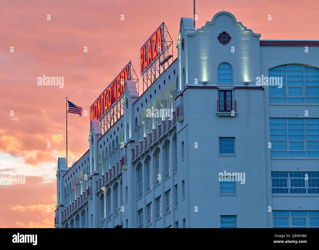Fiery sunset background to a converted warehouse to Apartments building ...