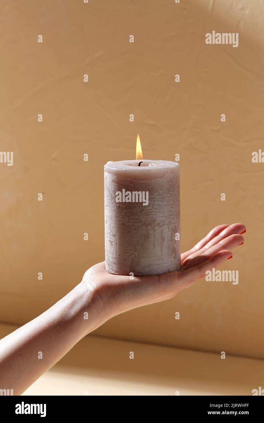 hand holding burning aroma candle on palm Stock Photo - Alamy