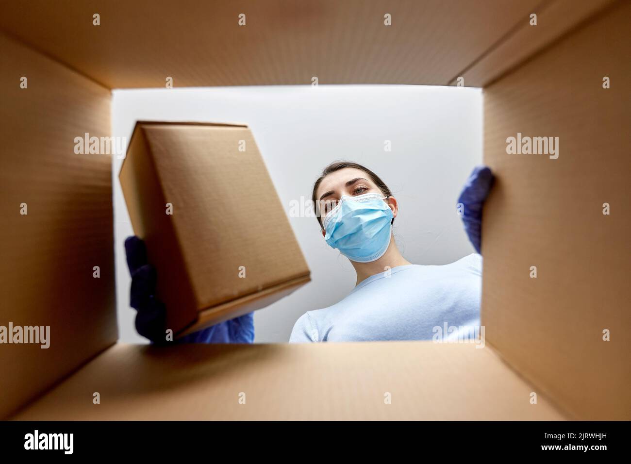 Woman unpacking parcel box hi-res stock photography and images - Alamy