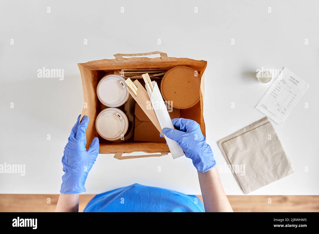 delivery woman in gloves packing food and drinks Stock Photo - Alamy
