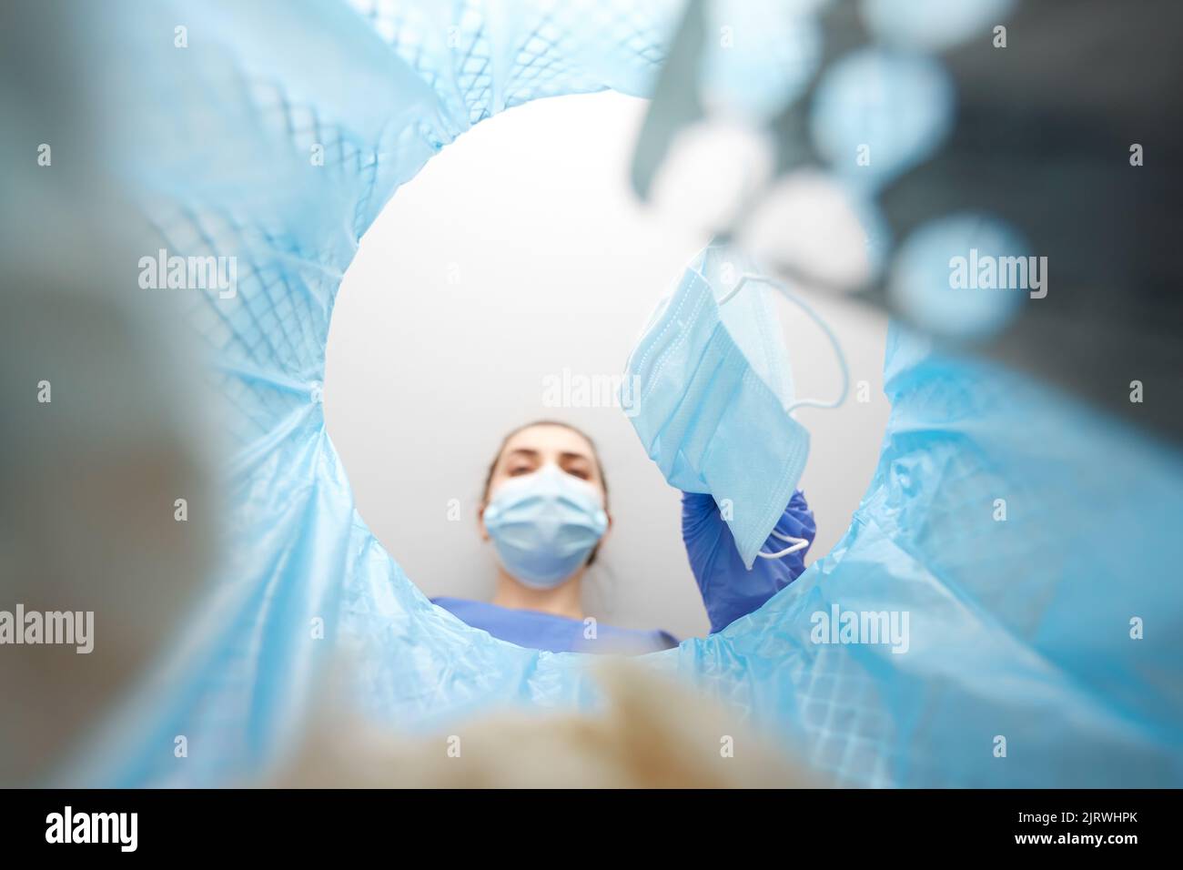 doctor throwing used medical mask into trash can Stock Photo - Alamy