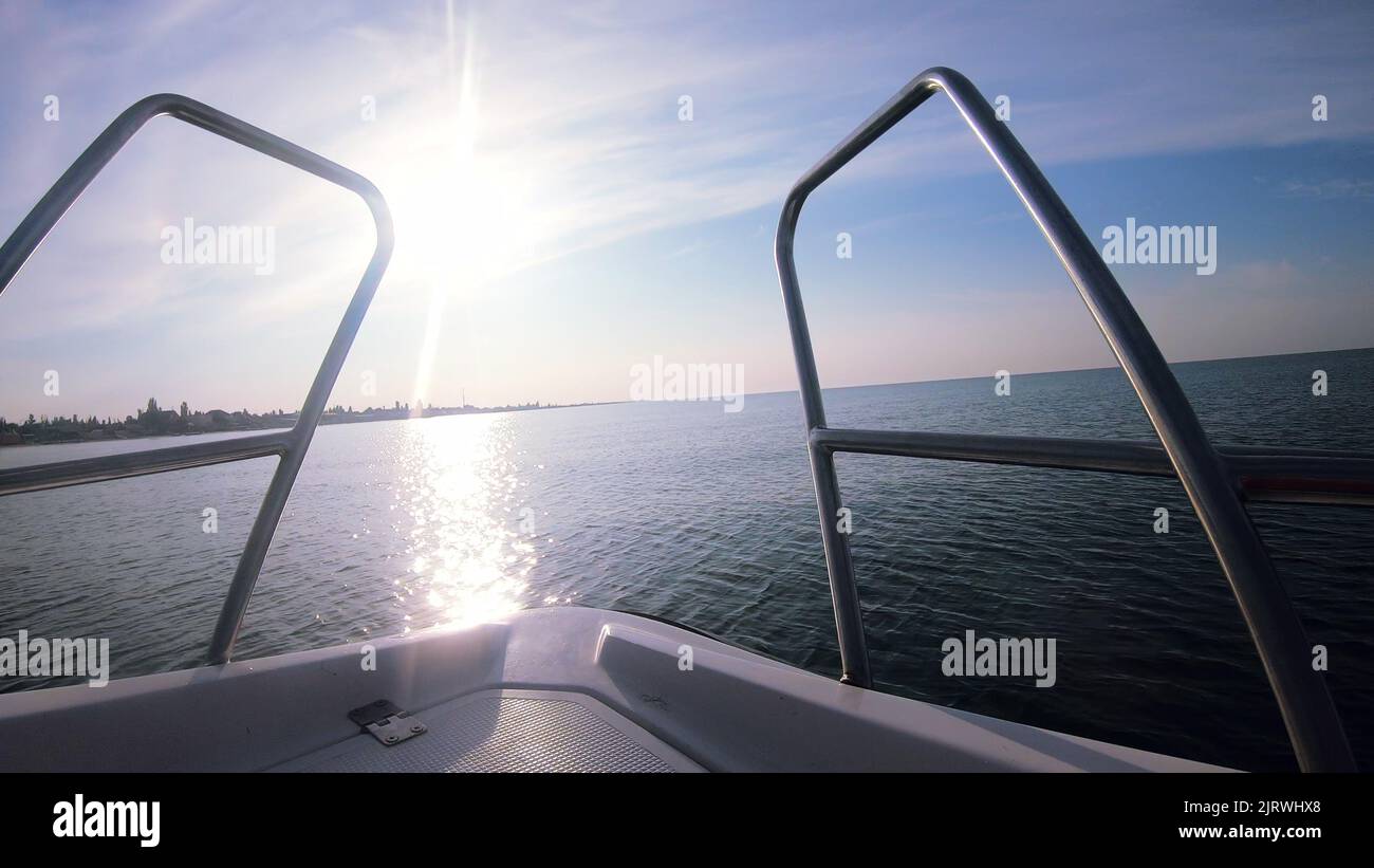 Seascape, view of sea waves with sun reflection from prow of motorboat ...