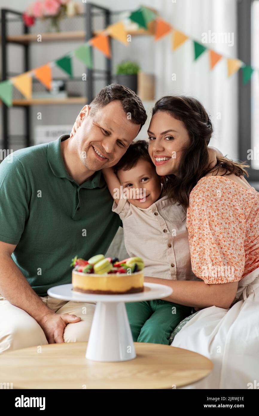 happy family with birthday cake hugging at home Stock Photo - Alamy
