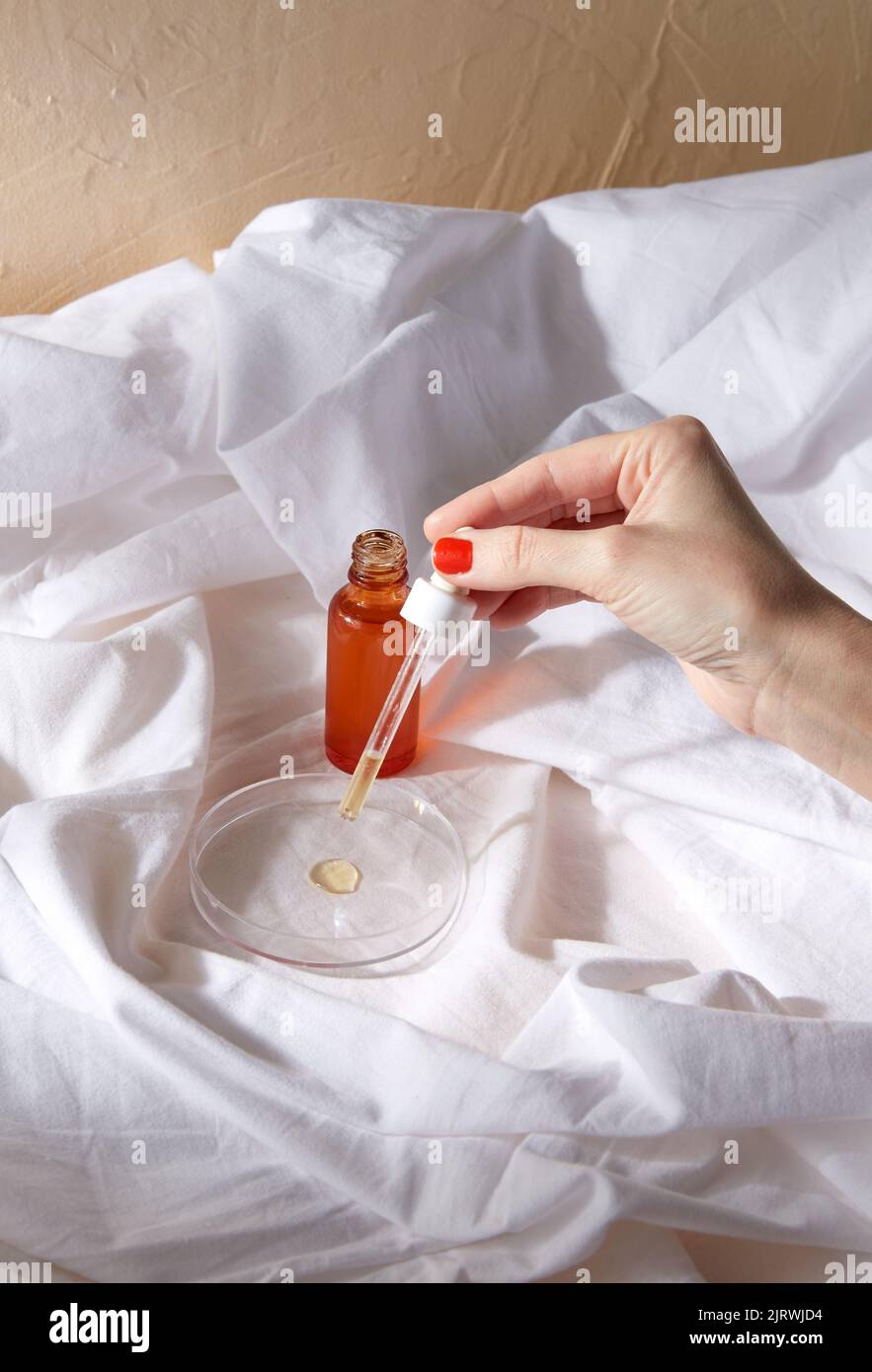 female hand with dropper applying serum to glass Stock Photo - Alamy