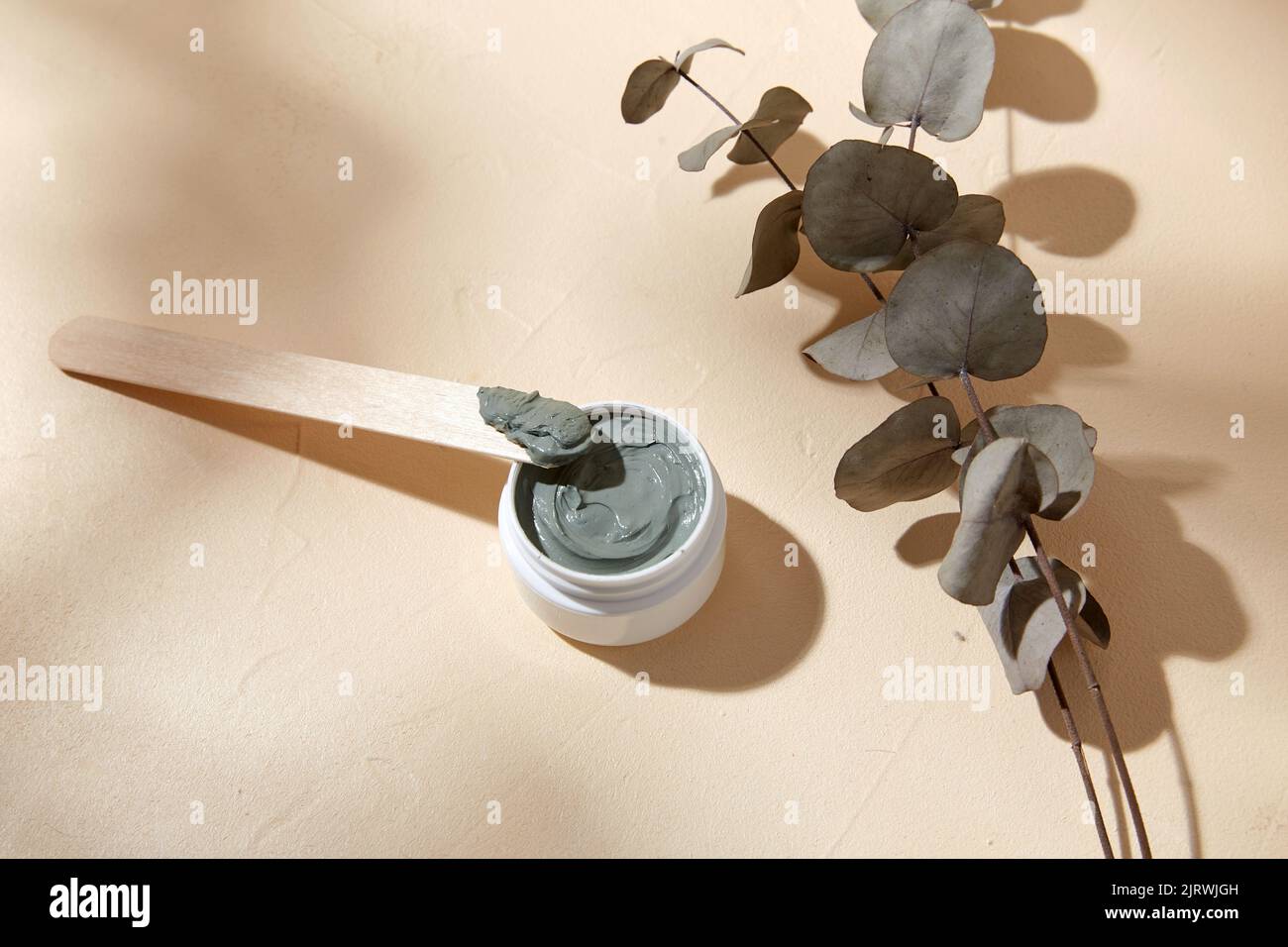 cosmetic clay mask in jar with wooden spatula Stock Photo - Alamy