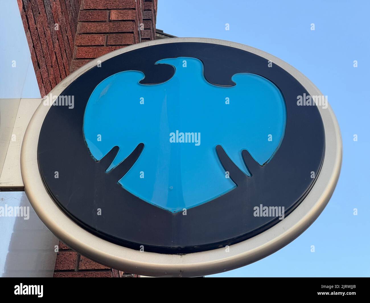 A blue logo of Barclays in front of the Bank in Rugby Stock Photo - Alamy