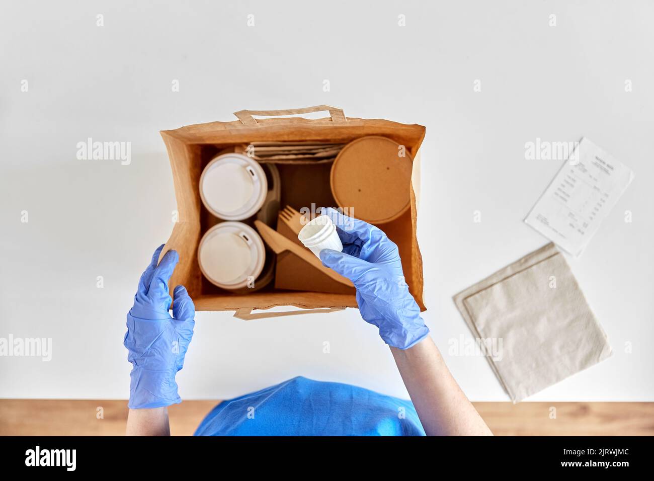 delivery woman in gloves packing food and drinks Stock Photo - Alamy