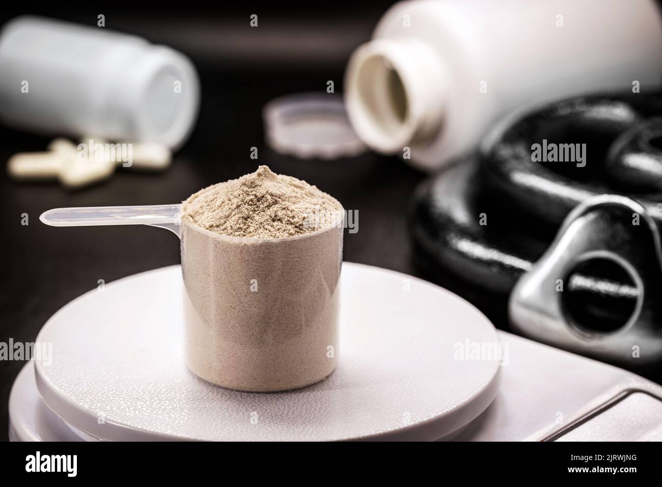 Measuring spoon with creatine or whey, on precision scale, preparing ...