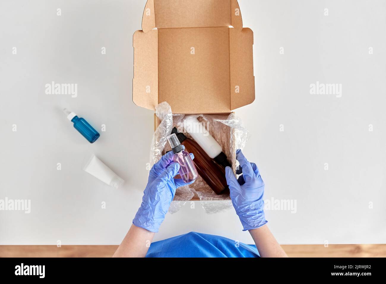 Hands in gloves packing parcel hi-res stock photography and images - Alamy