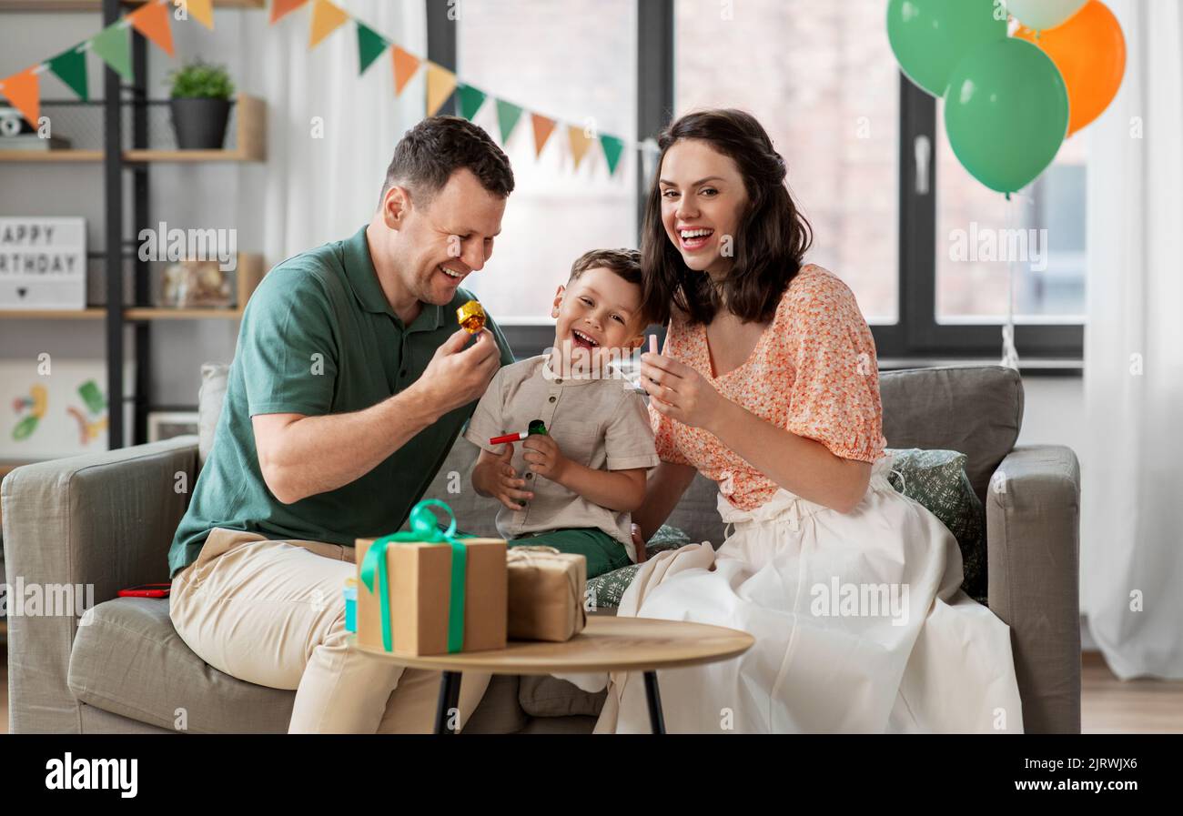 happy family with gifts and party blowers at home Stock Photo - Alamy