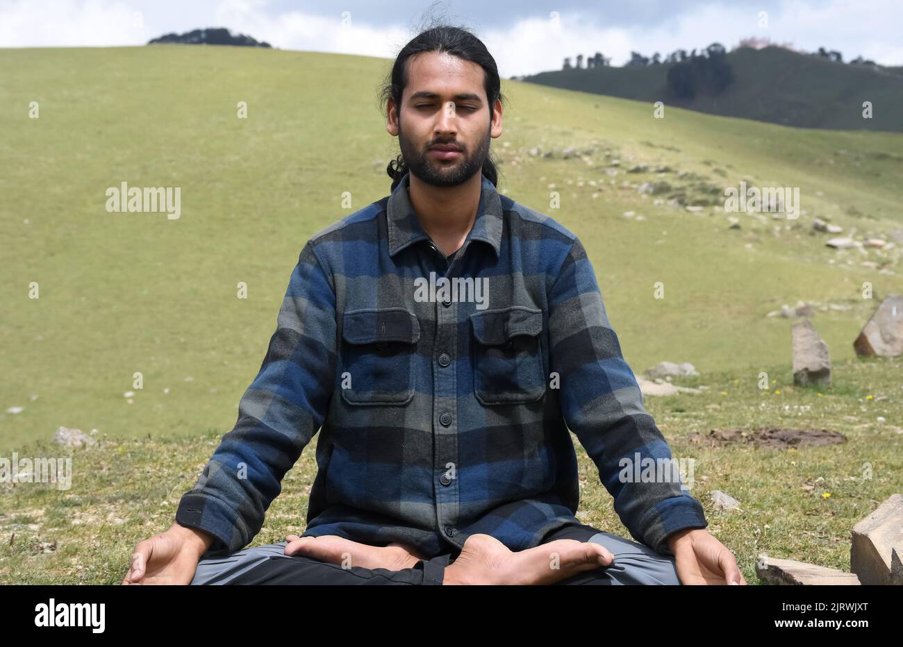 Front view of a young Indian guy practicing Meditation, Yoga in Lotus ...