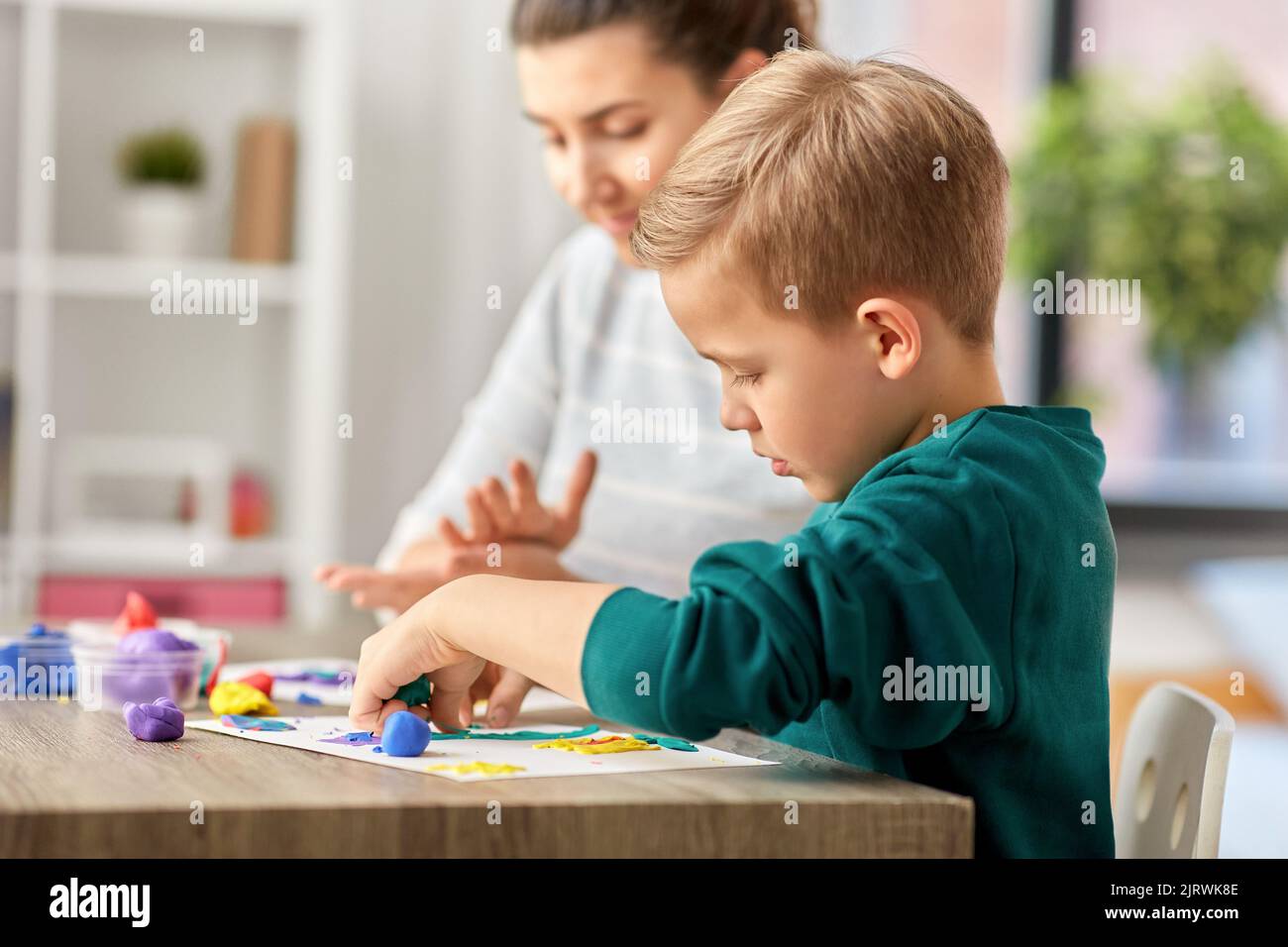 mother and son playing with modeling clay at home Stock Photo - Alamy