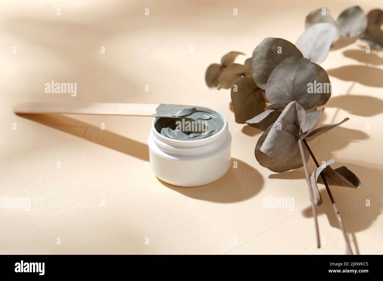 cosmetic clay mask in jar with wooden spatula Stock Photo - Alamy