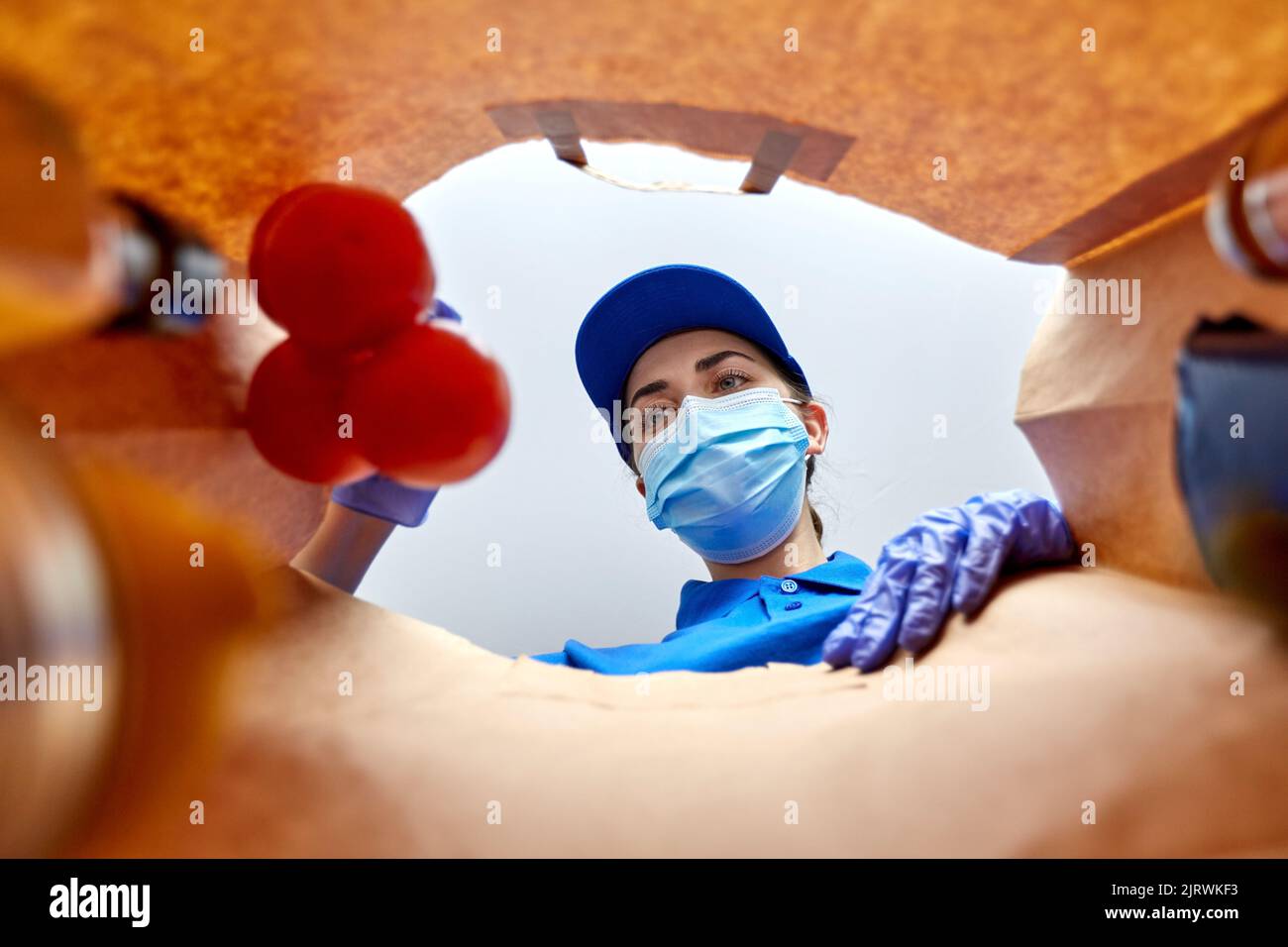 delivery girl in gloves and mask with food in bag Stock Photo - Alamy