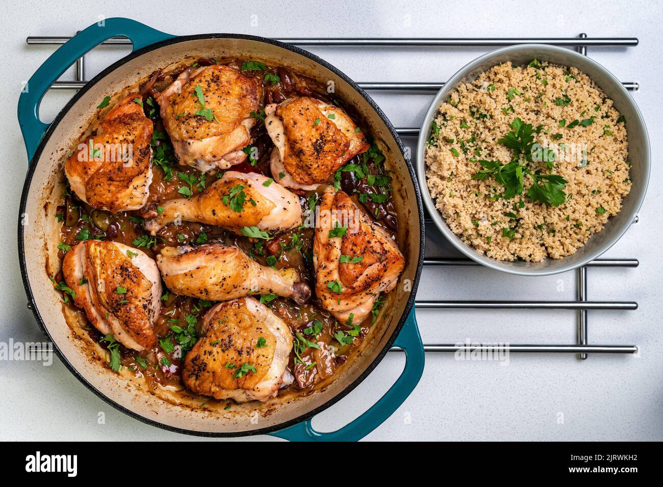 A top view of Umbrian-Style Chicken alla Cacciatora in a pan near a ...
