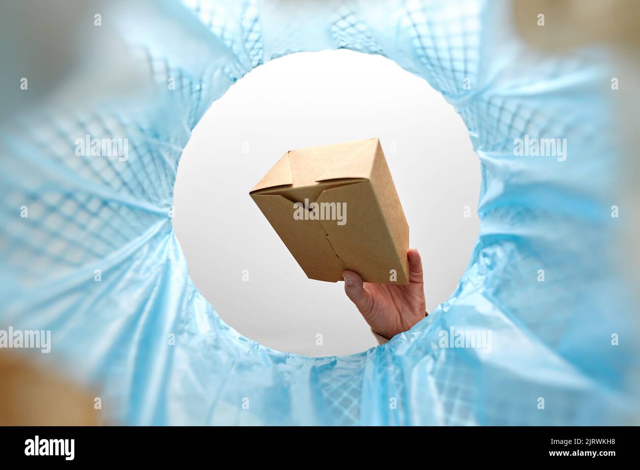hand throwing paper box into trash can Stock Photo - Alamy