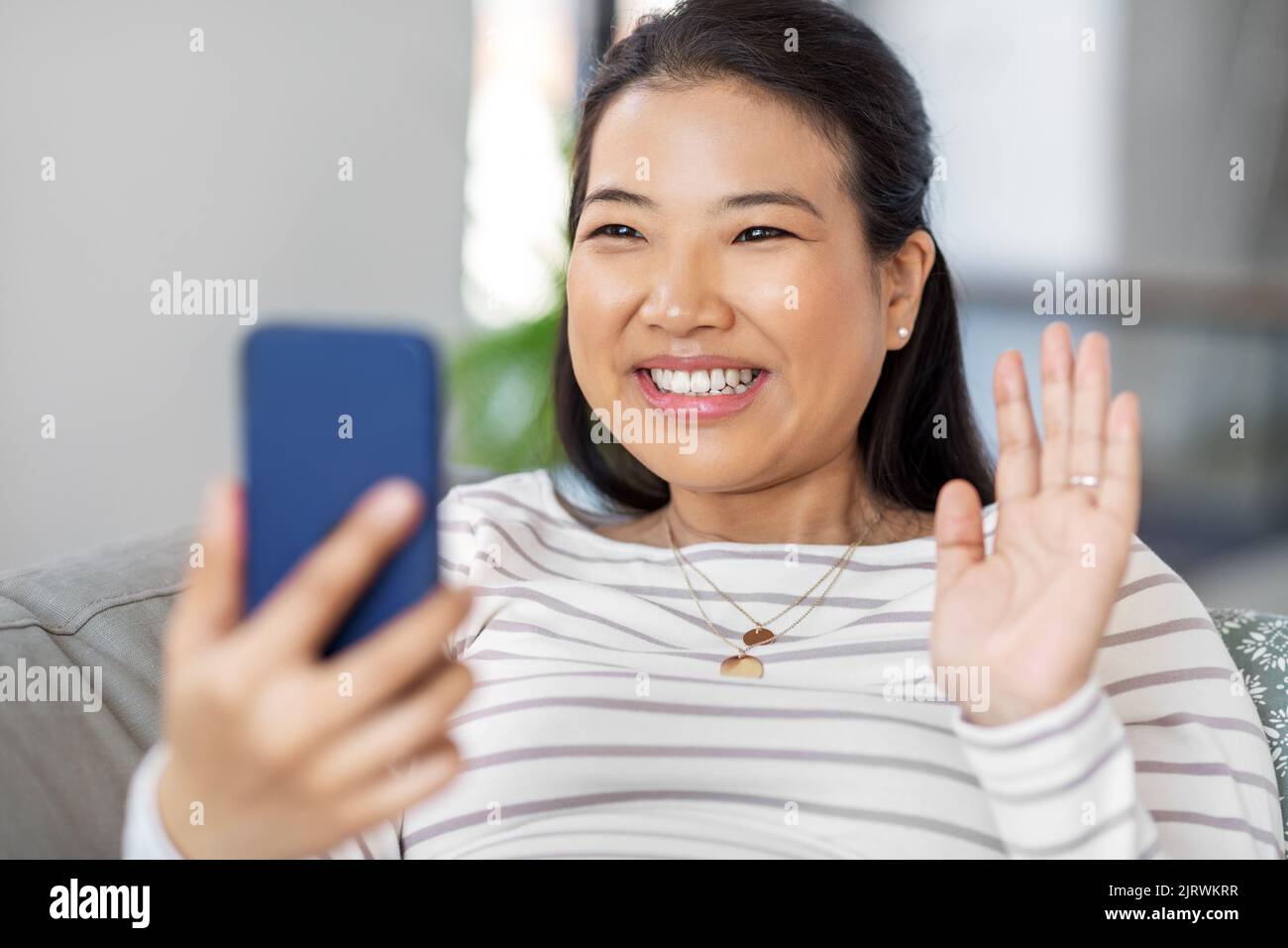 asian woman with smartphone having video call Stock Photo - Alamy