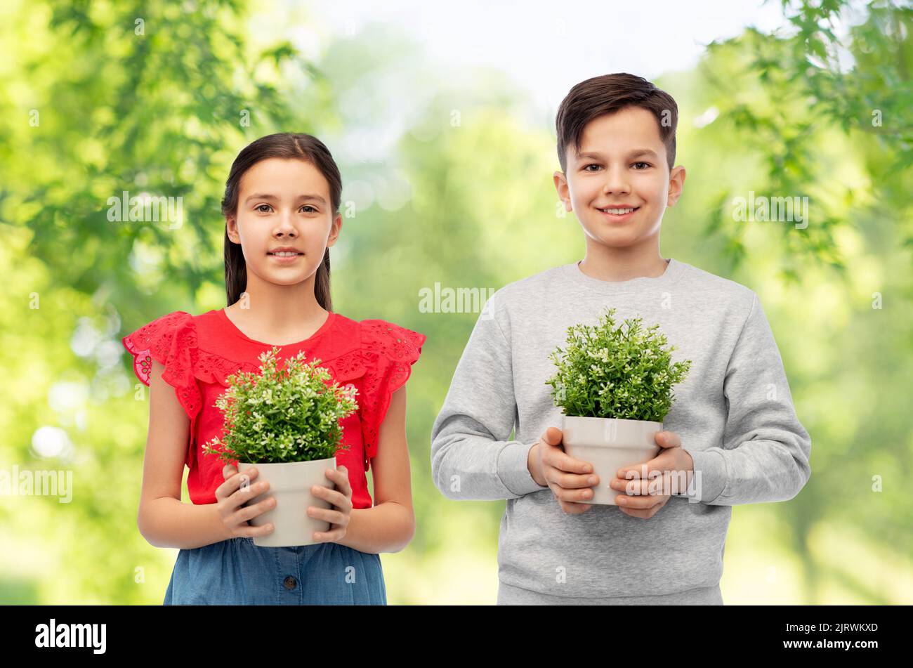 happy smiling children holding flower in pot Stock Photo - Alamy