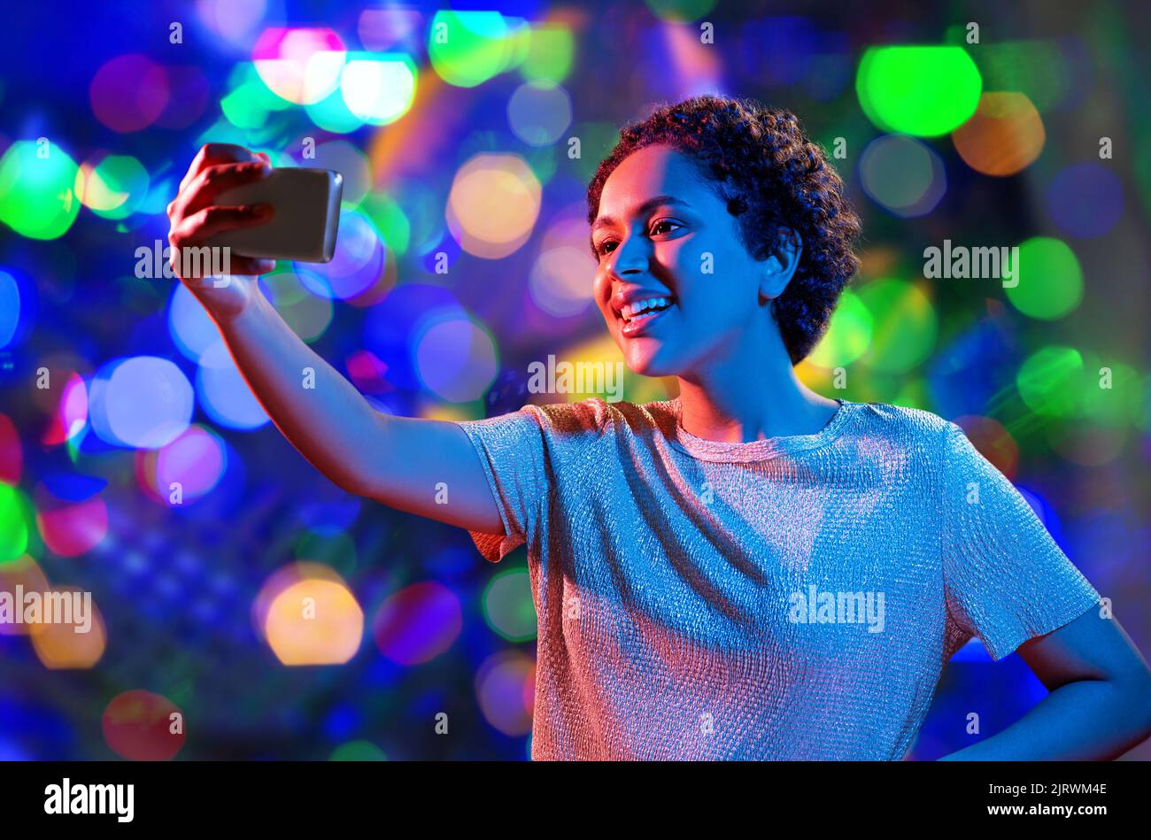 woman taking selfie with smartphone in neon lights Stock Photo - Alamy