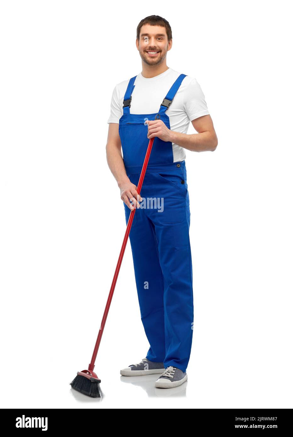 male cleaner in overall cleaning floor with broom Stock Photo - Alamy