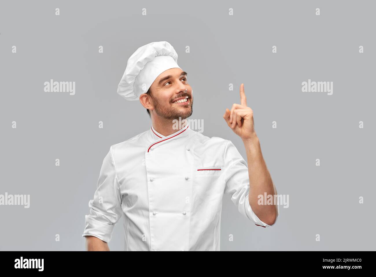 happy smiling male chef pointing finger up Stock Photo - Alamy