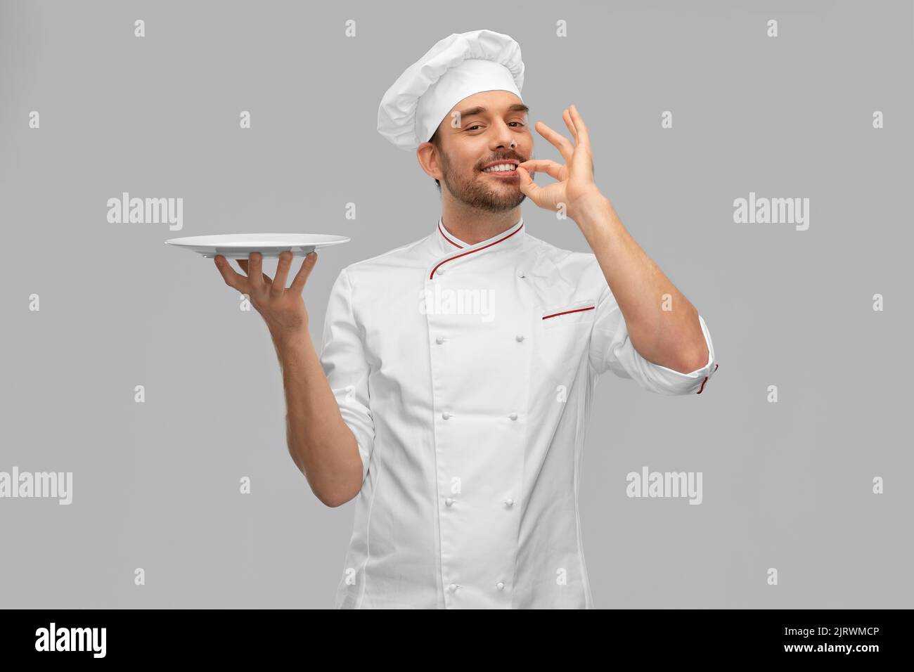 happy smiling male chef holding empty plate Stock Photo - Alamy