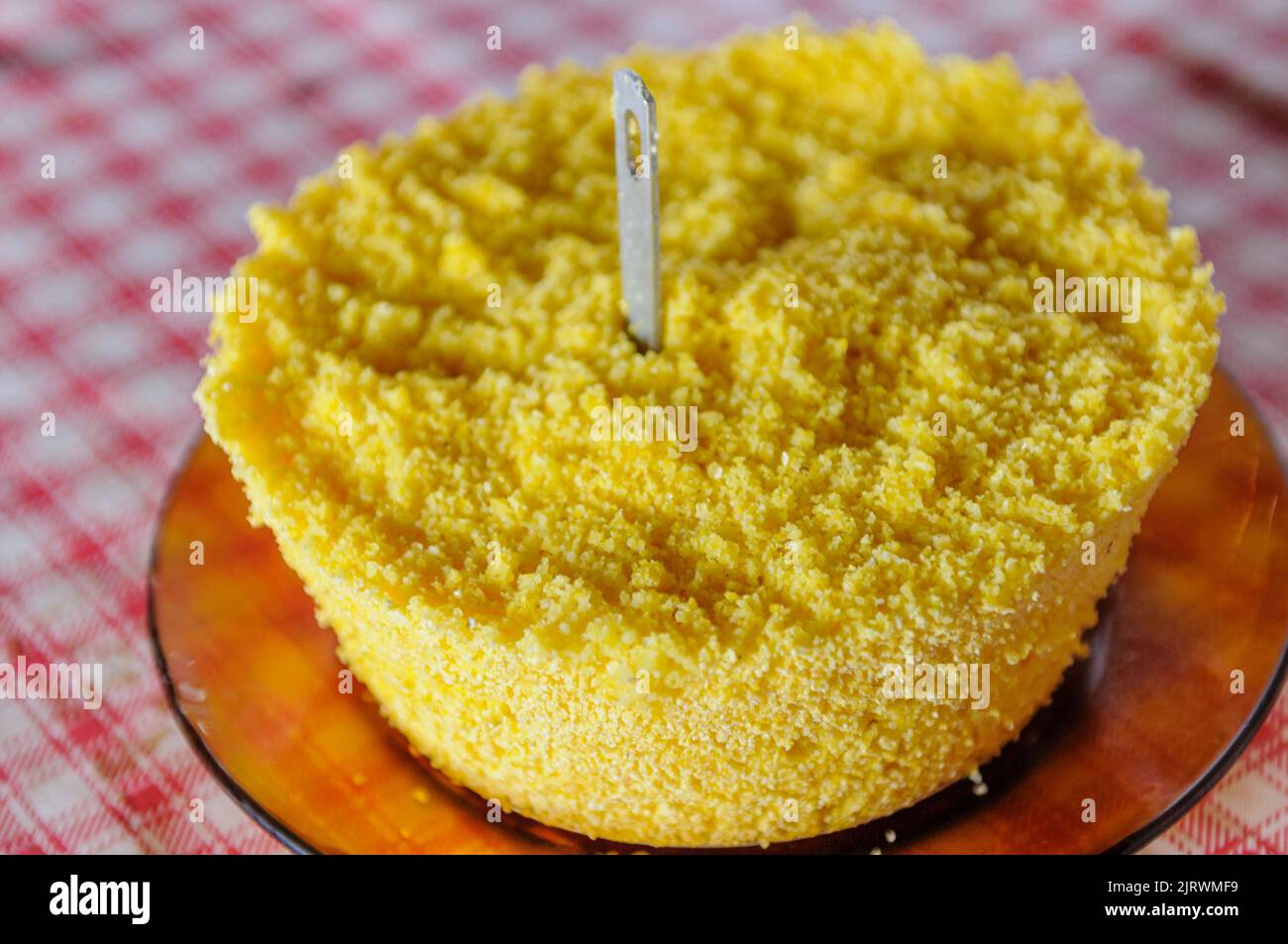Corn couscous on table with red and white tablecloth. Popular dish from ...