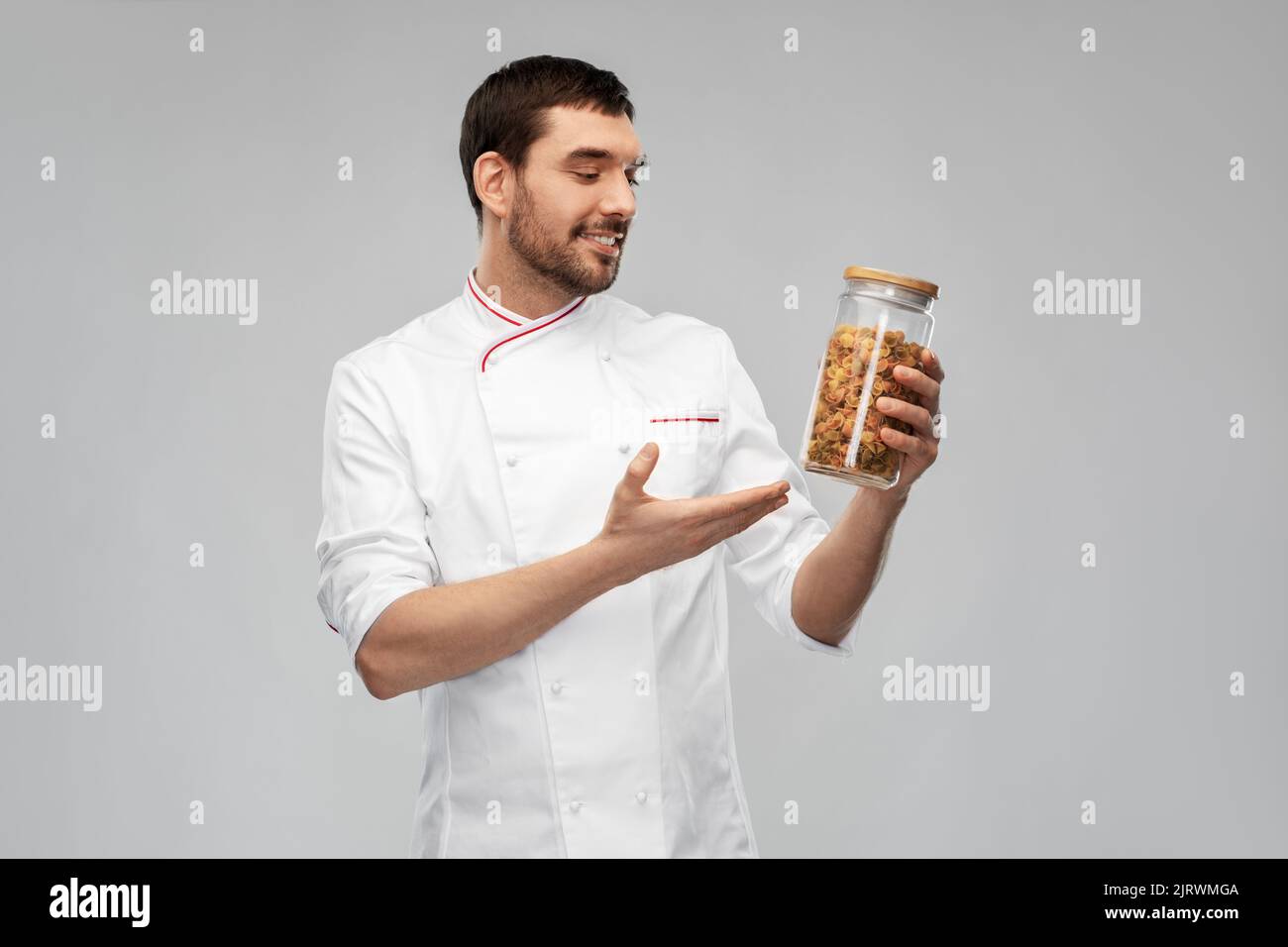 happy smiling male chef with pasta in glass jar Stock Photo - Alamy