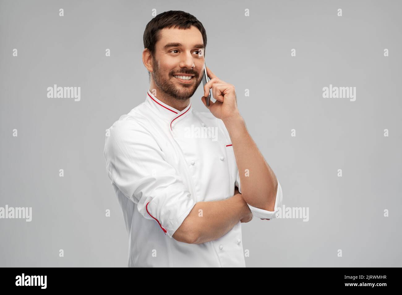 happy smiling male chef calling on smartphone Stock Photo - Alamy
