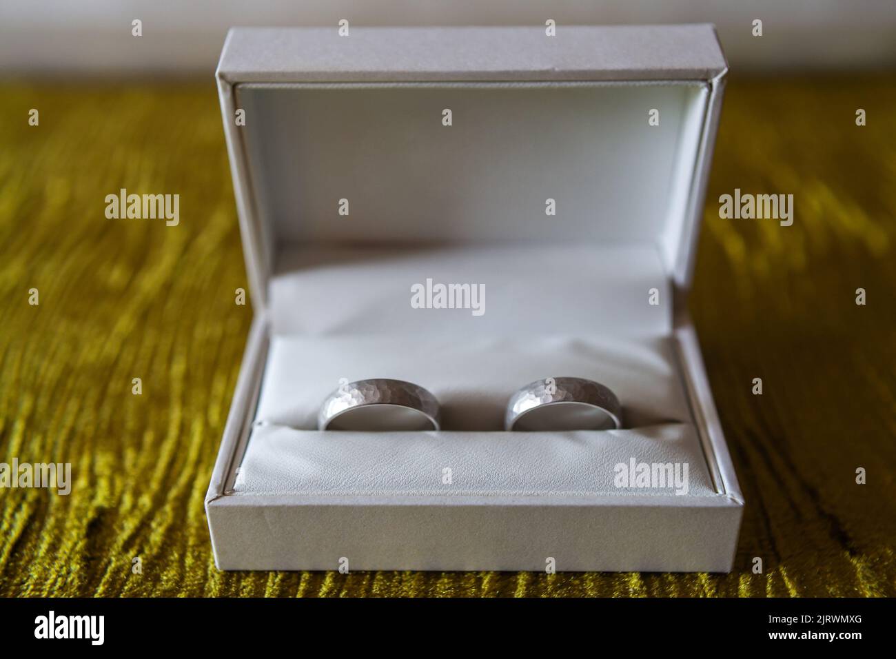 Two wedding rings in a white box Stock Photo - Alamy