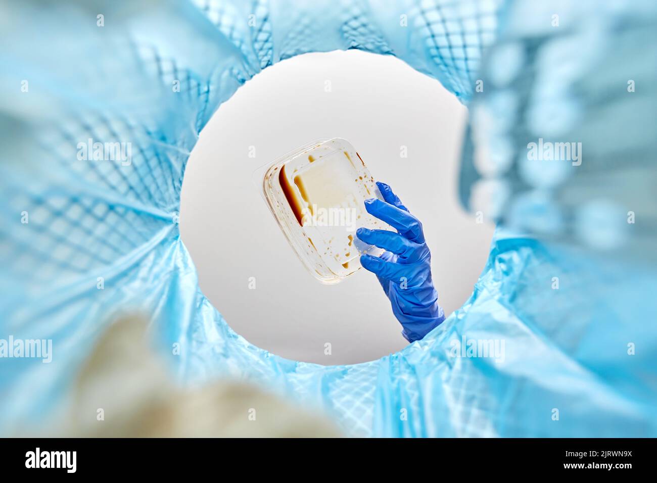 hand throwing plastic container into trash can Stock Photo - Alamy