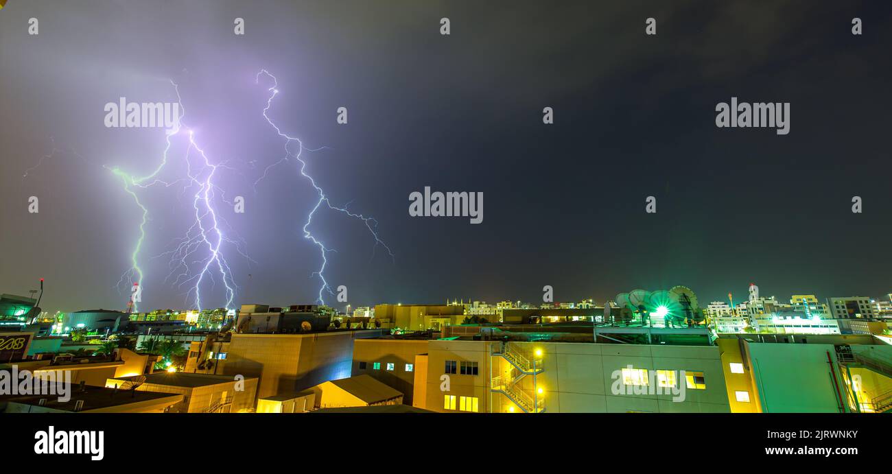 A flash of striking lightning over the city at night Stock Photo - Alamy