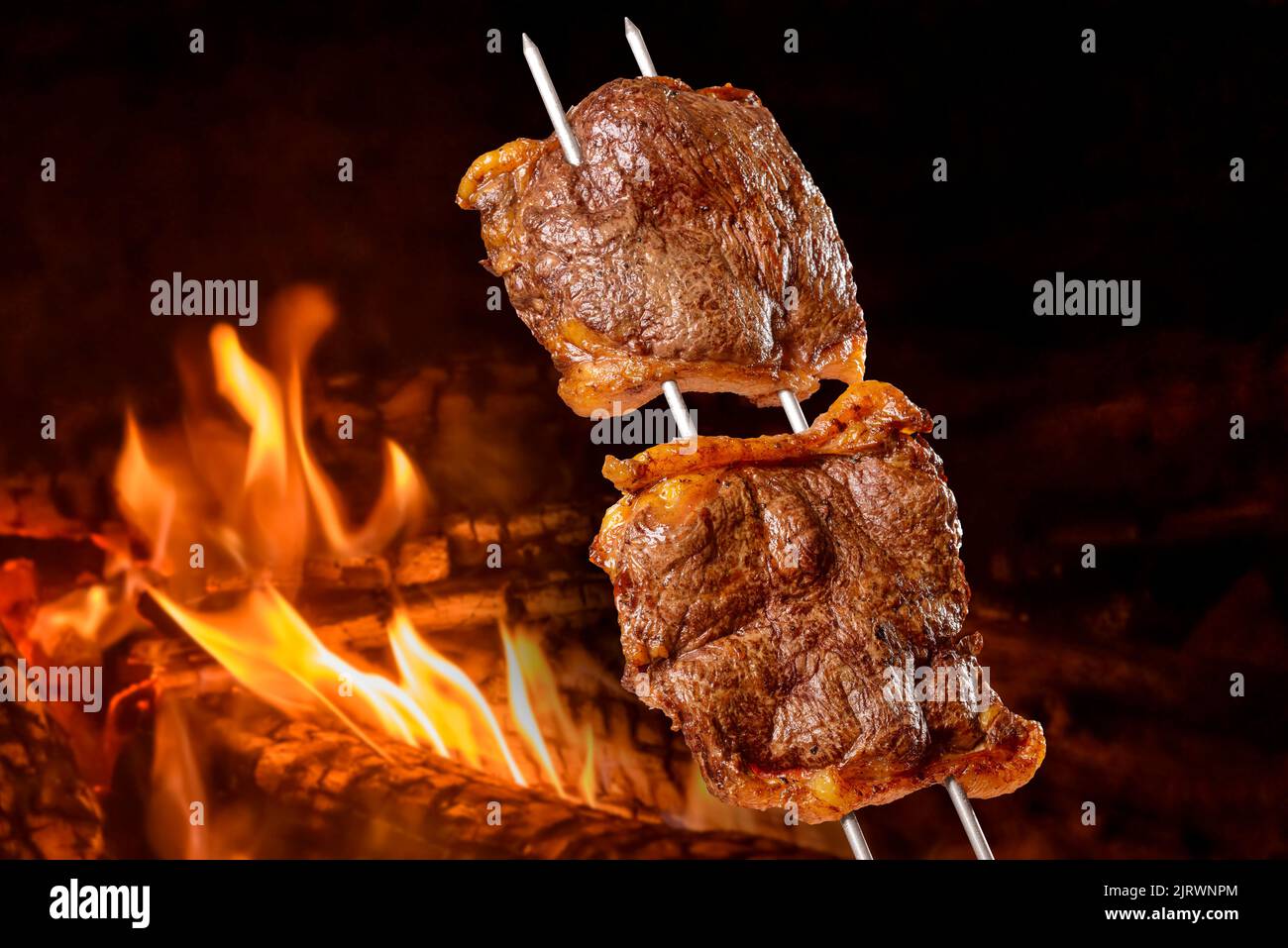 Picanha barbecue roasted on the spit on the coals. This type of ...