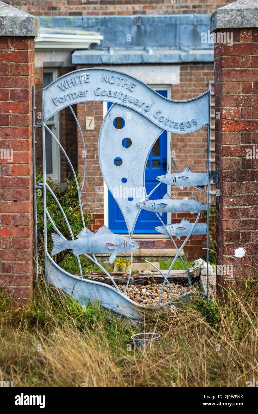 Ornate metal gate to former coastguard cottages at White Nothe ...