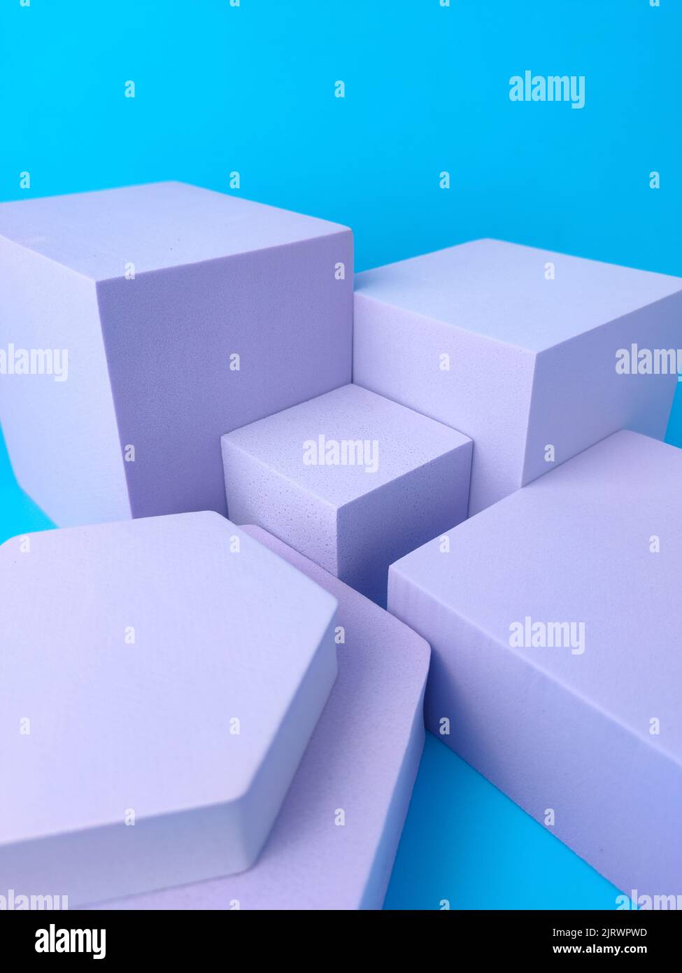 A 3D rendering of purple podiums for product presentation on blue ...