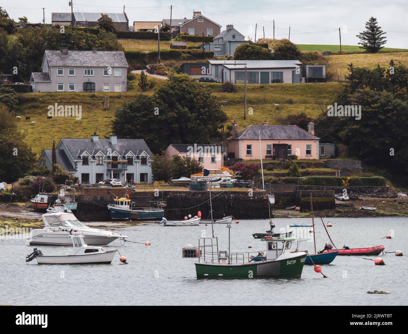Clonakilty, Ireland, July 2, 2022. Fishing boats are anchored near the ...