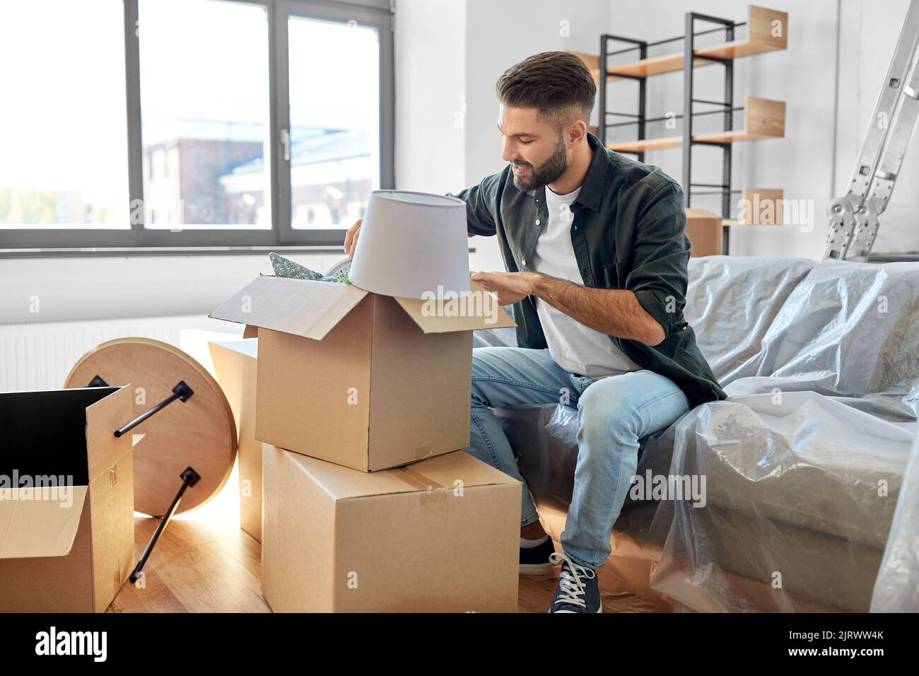 Happy man unpacking new hi-res stock photography and images - Alamy