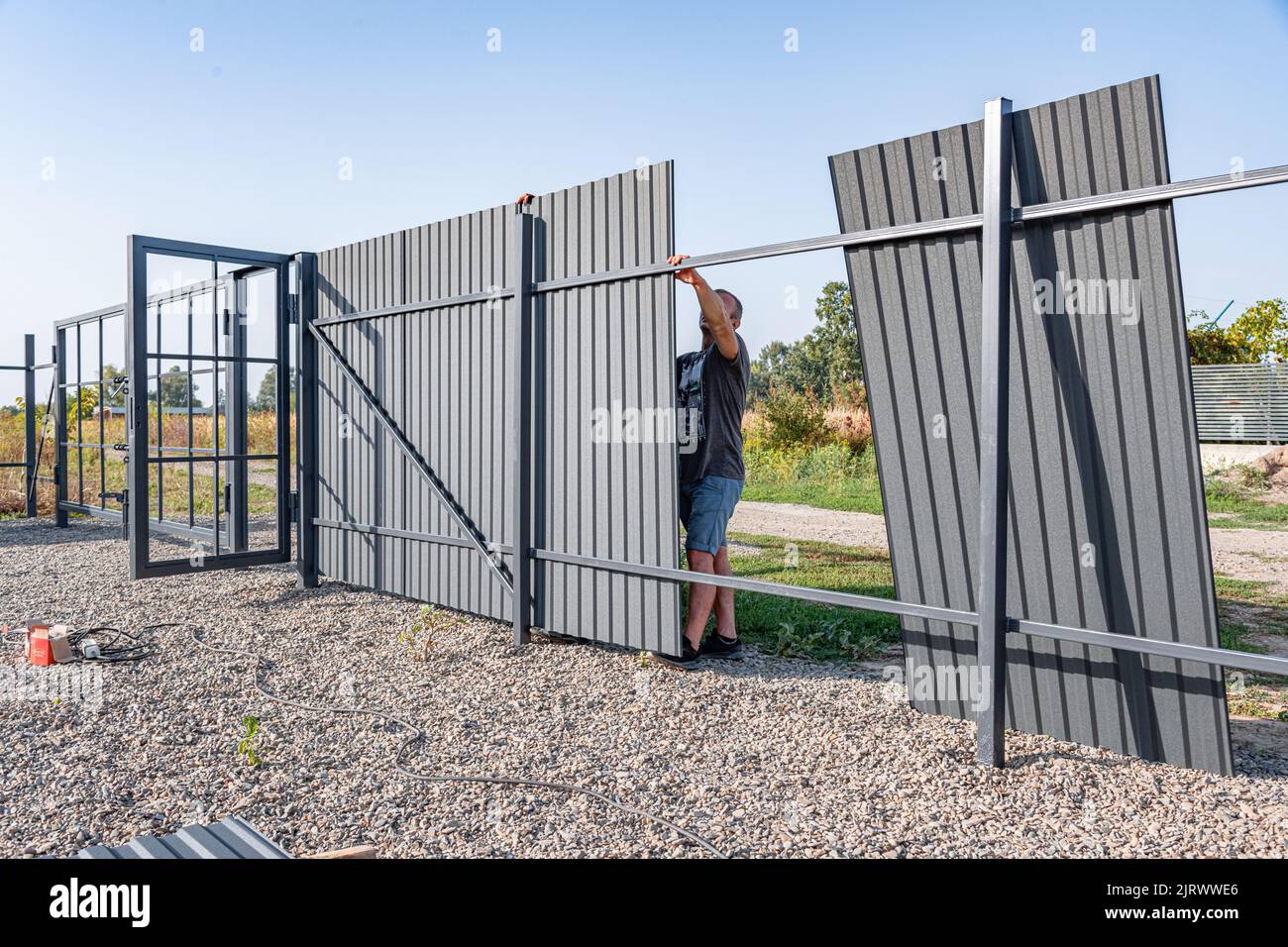 Installation of metal gates Stock Photo - Alamy
