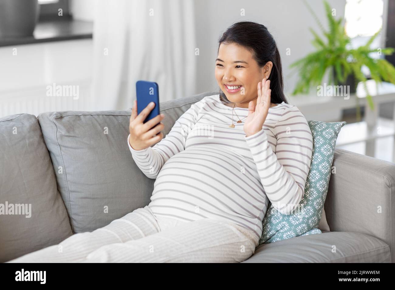 happy pregnant woman having video call on phone Stock Photo - Alamy