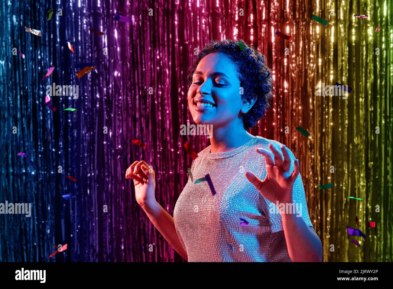 african woman under confetti at nightclub party Stock Photo - Alamy